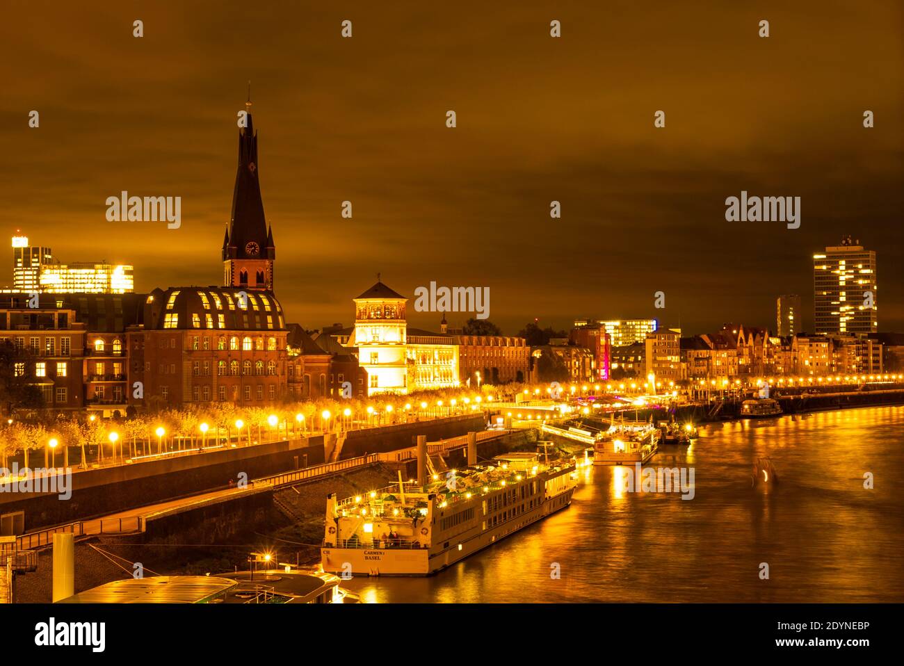 Night view of Dusseldorf on the bank of Rhine in Germany; Cruise ship ...