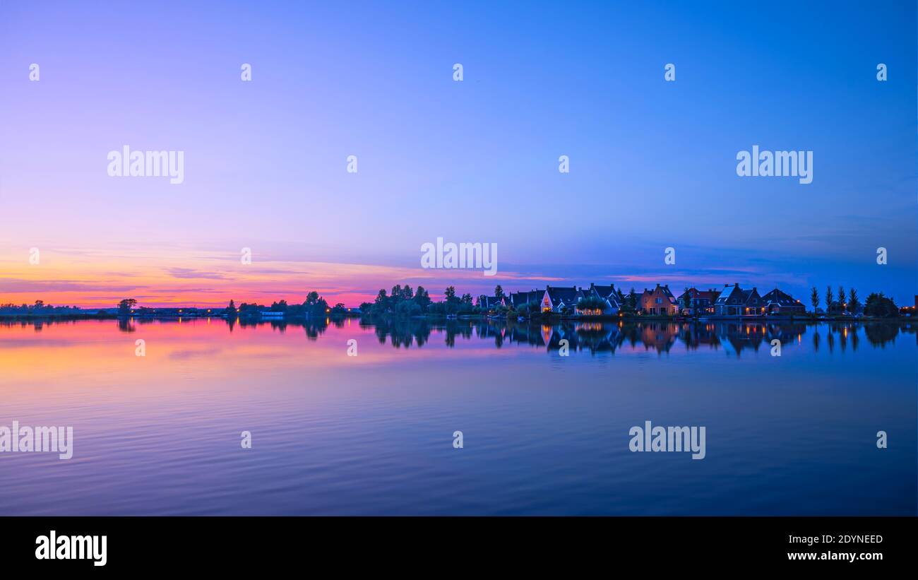 The lake and town at sunset; beautiful sunset Stock Photo - Alamy