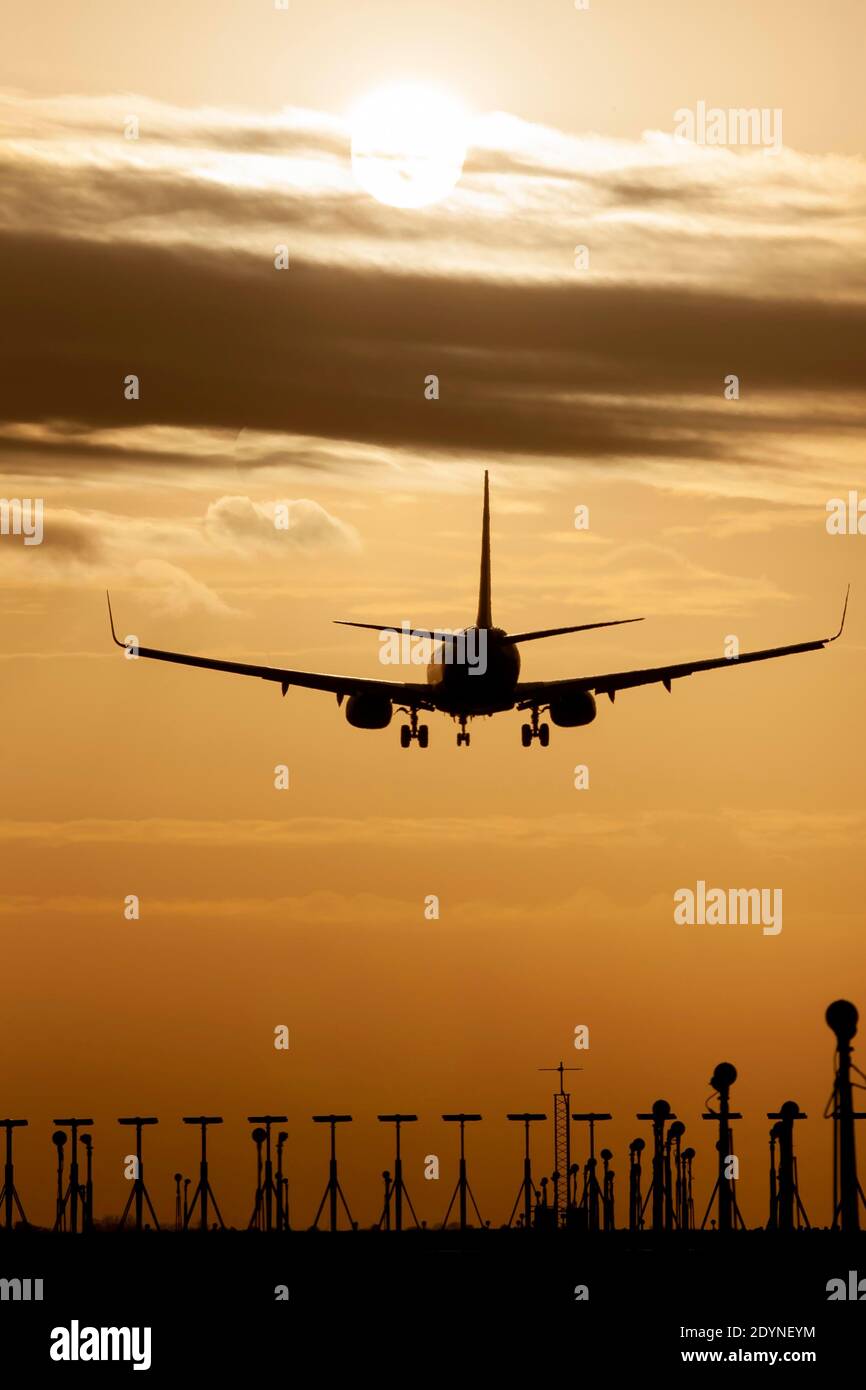Boeing 737 aircraft landing at an airport at sunset, Stansted, Essex ...