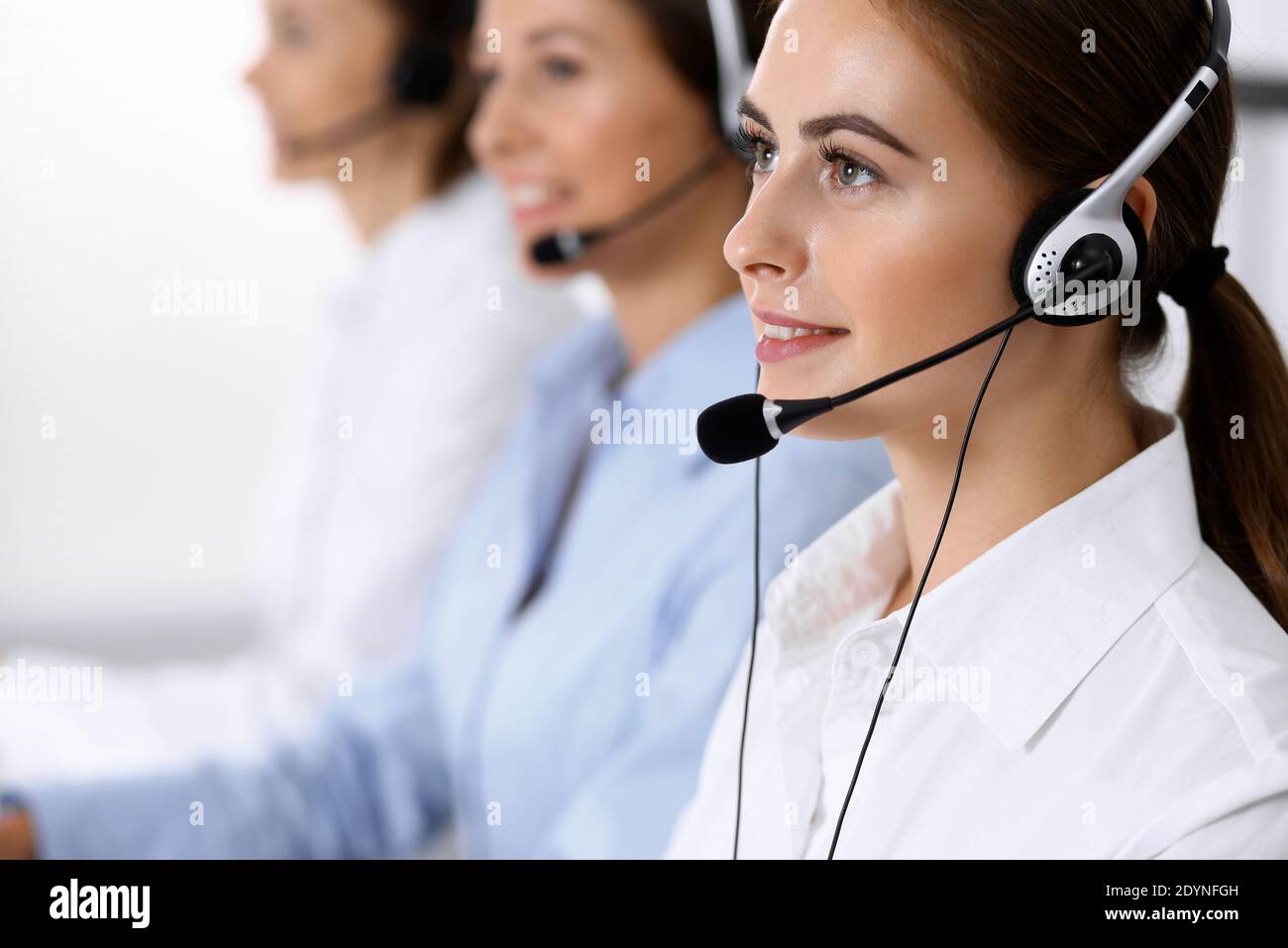 Call center. Group of operators at work. Fo us on beautiful business woman in headset Stock ...
