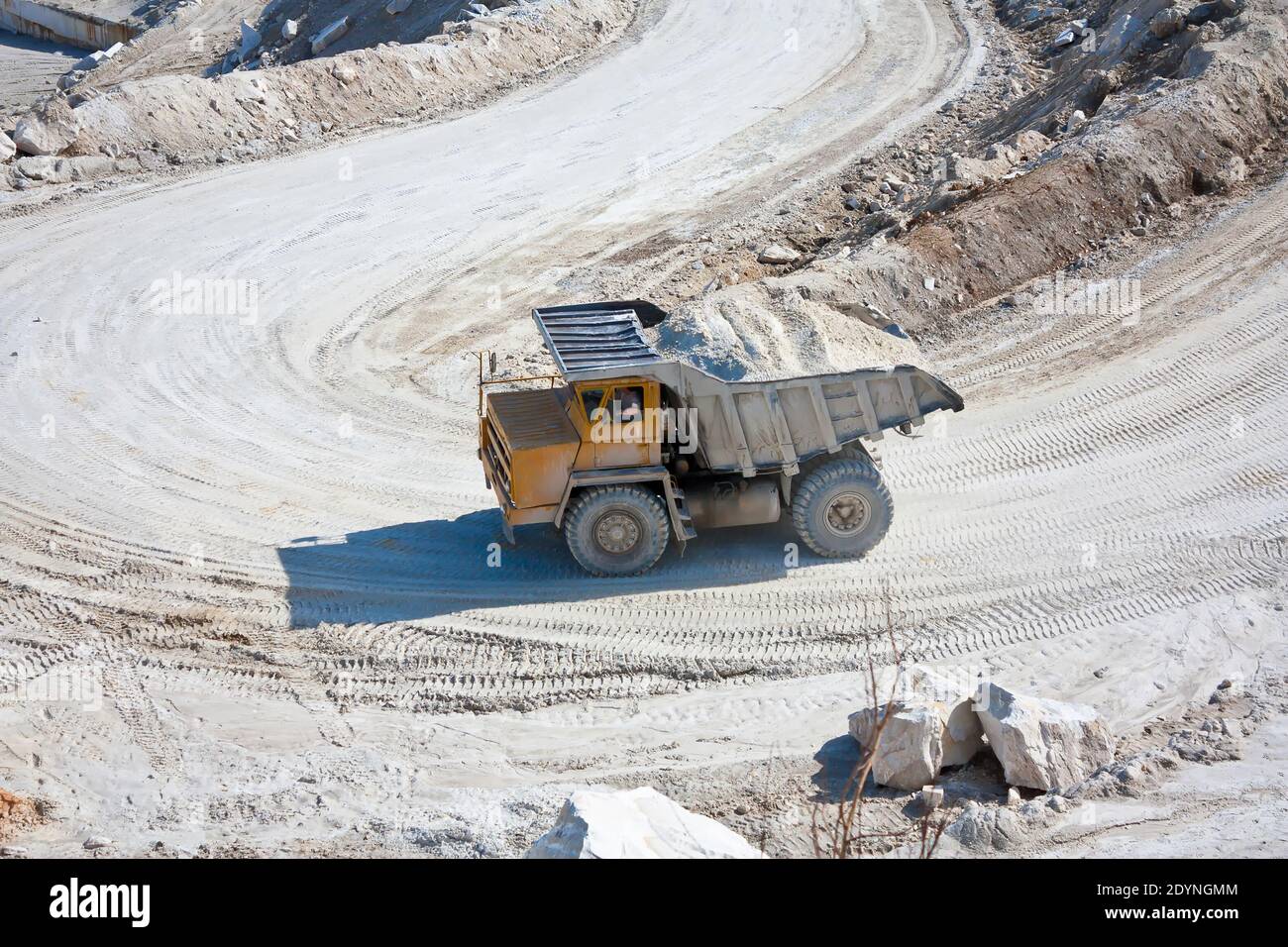 Big dumper carries ore in a marble quarry Stock Photo - Alamy