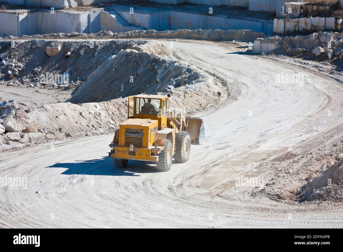 Yellow wheel tractor loader in a marble quarry Stock Photo - Alamy