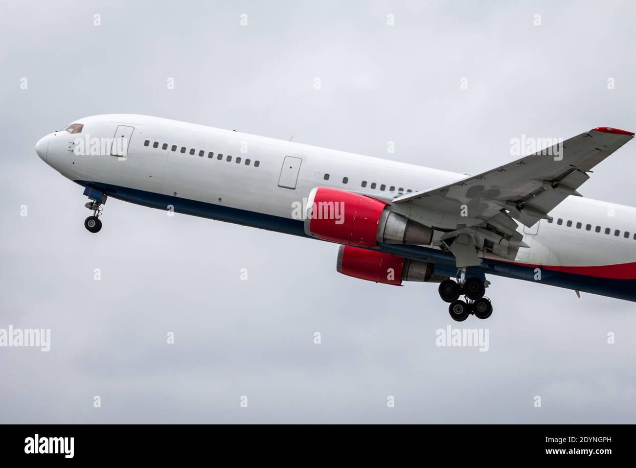 Modern wide-body passenger airplane flies in the air Stock Photo - Alamy