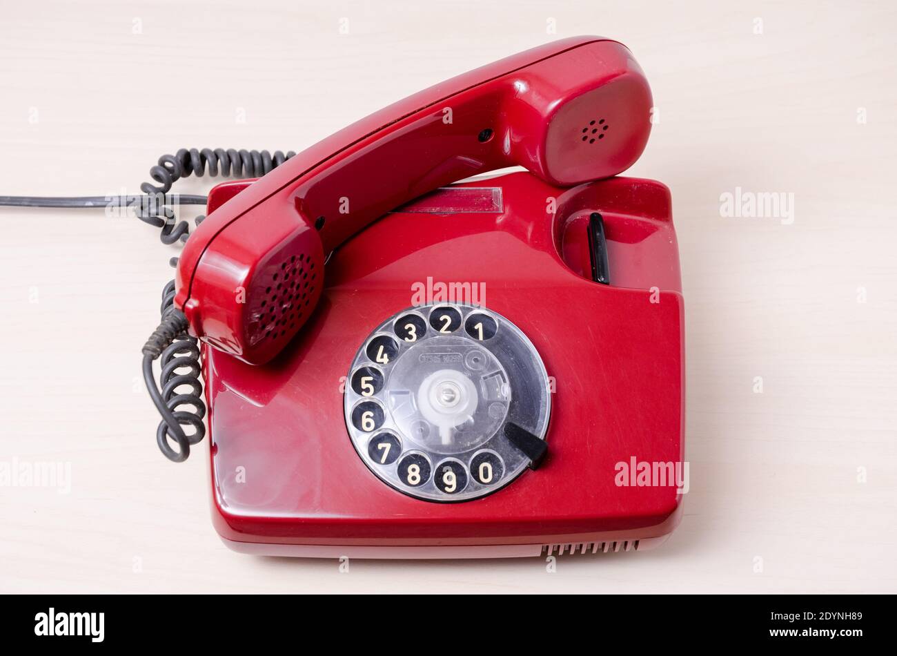 Classic vintage red telephone with rotary dial from the 80s or 90s ...