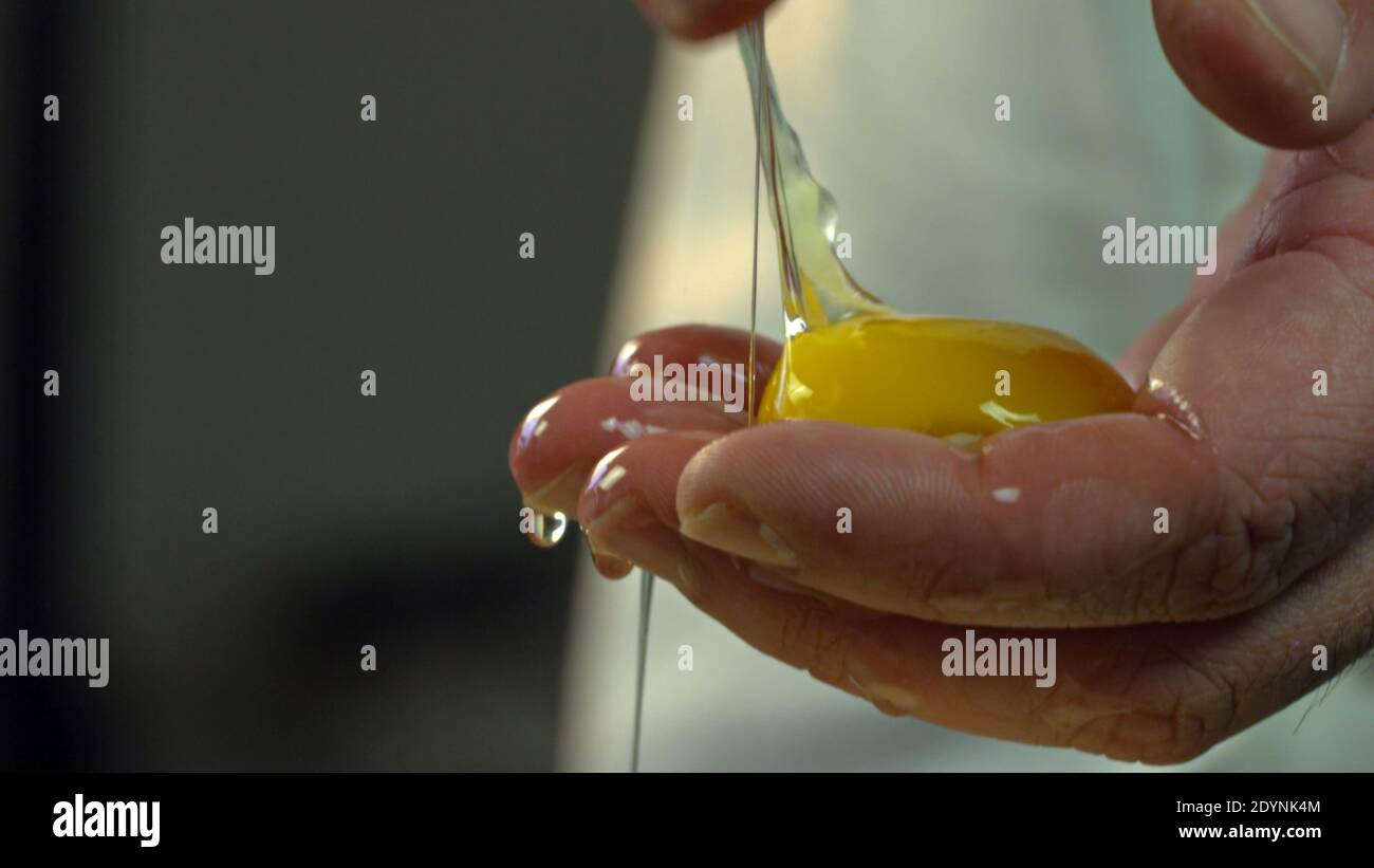 Pouring The Egg Into a Plate Stock Photo - Alamy