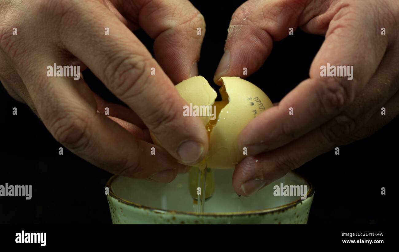 Pouring The Egg Into a Plate Stock Photo - Alamy