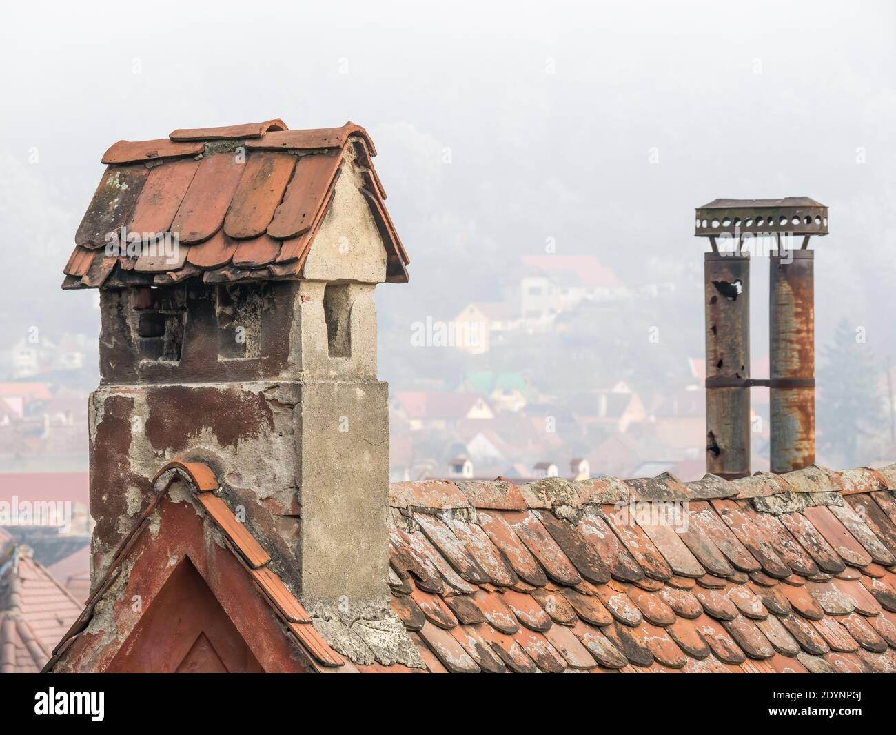 Old medieval house with red brick roof tiles and a chimney in ...