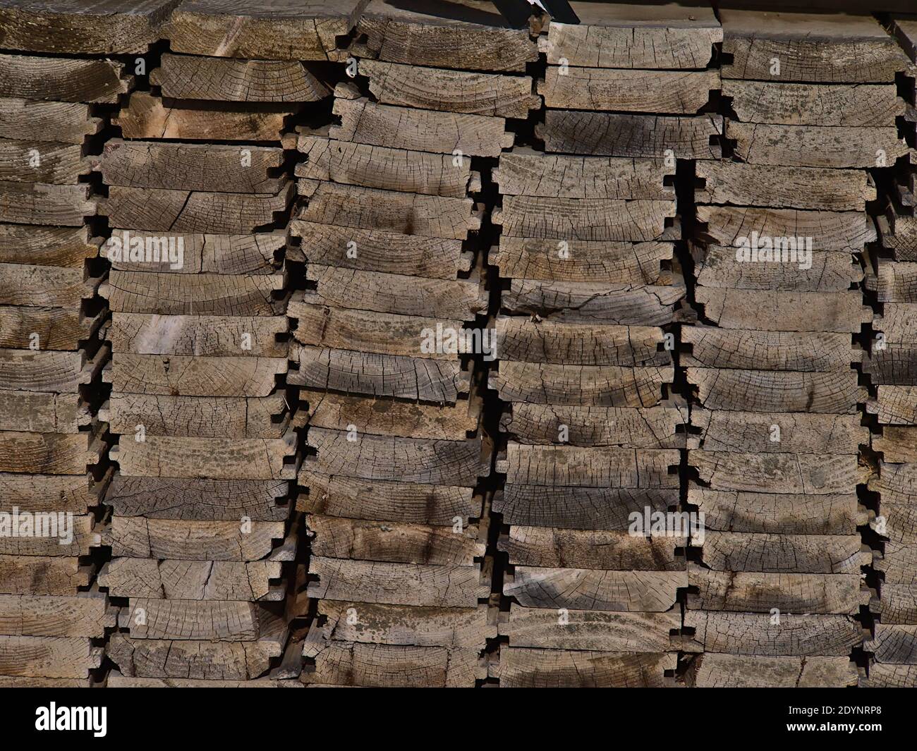 Closeup view of weathered pile of stacked wooden planks with wood ...