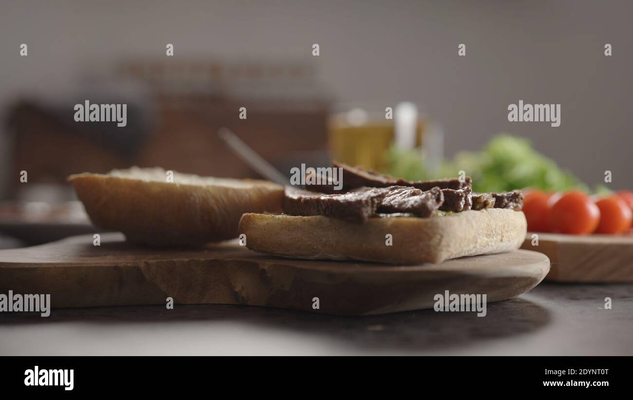 steak slices on on small ciabatta bun for sandwich on kitchen ...