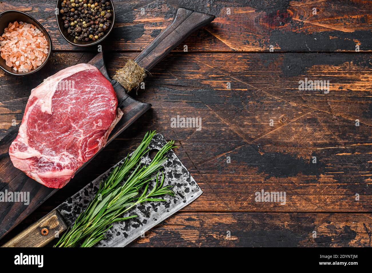 Raw beef meat Club or striploin on the bone steak. Dark wooden ...