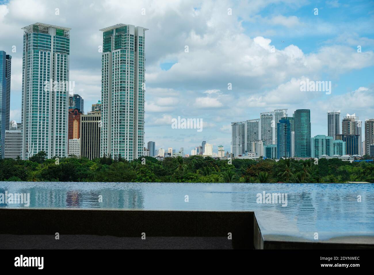 View of the city of Manila from the pool in a chic five-star hotel ...
