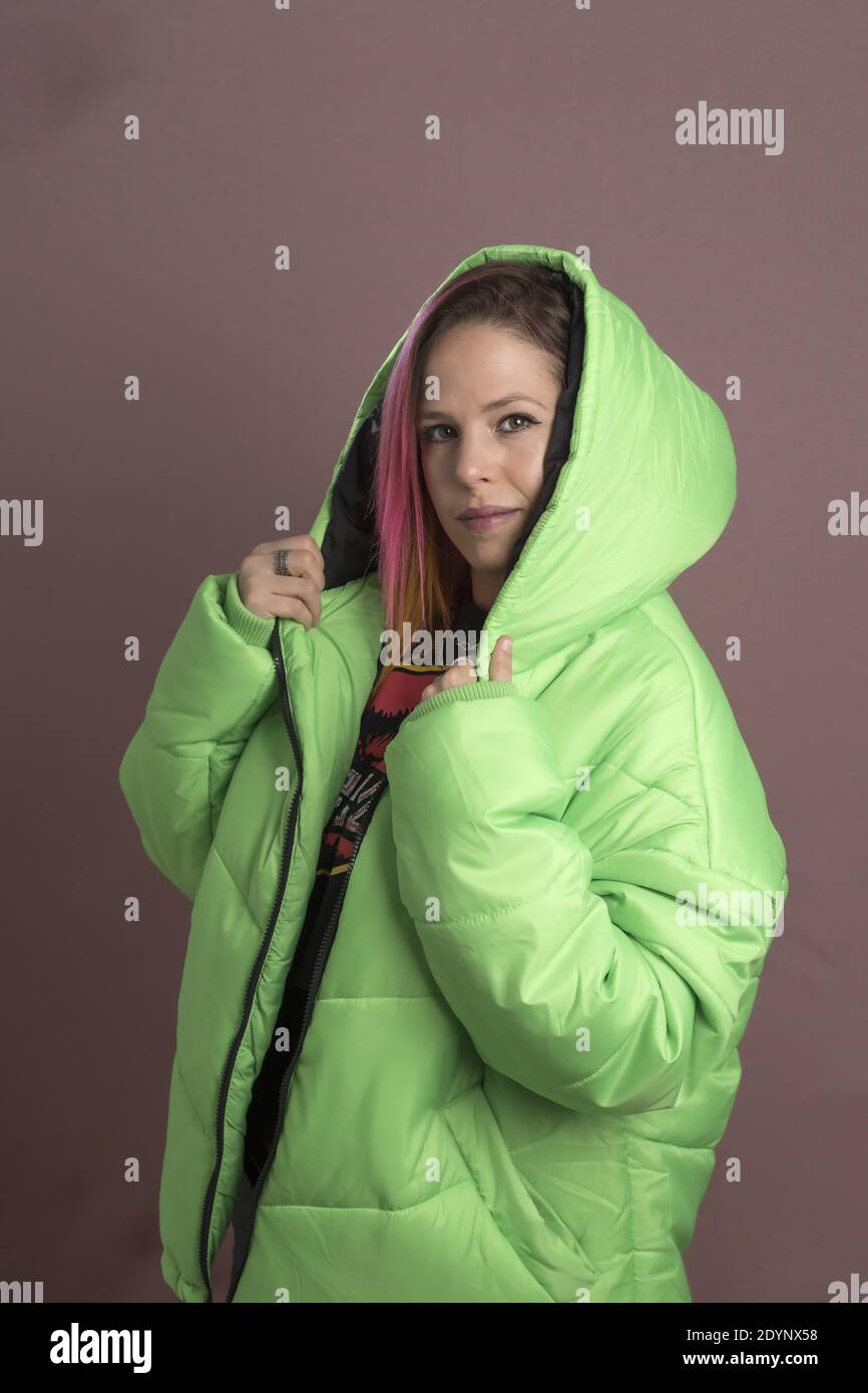 A young female with pink hair wearing a green puffer jacket Stock Photo ...