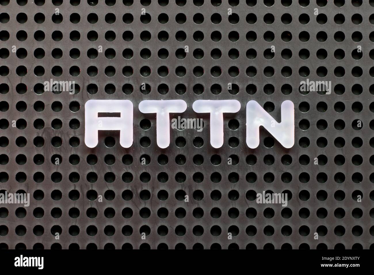 White color letter in word attn (Abbreviation of attention) on black ...