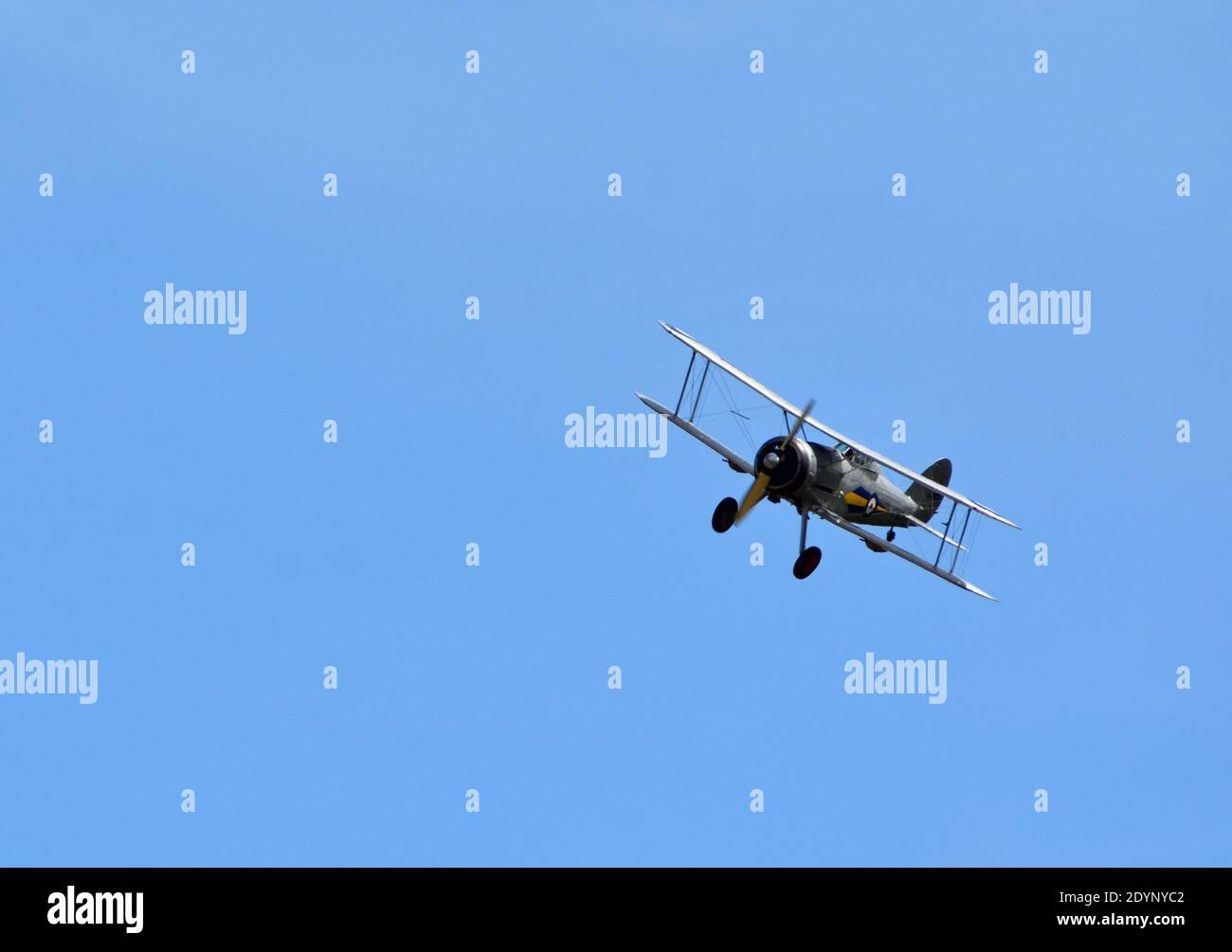 Vintage Gloster Gladiator aircraft in flight with blue sky background ...