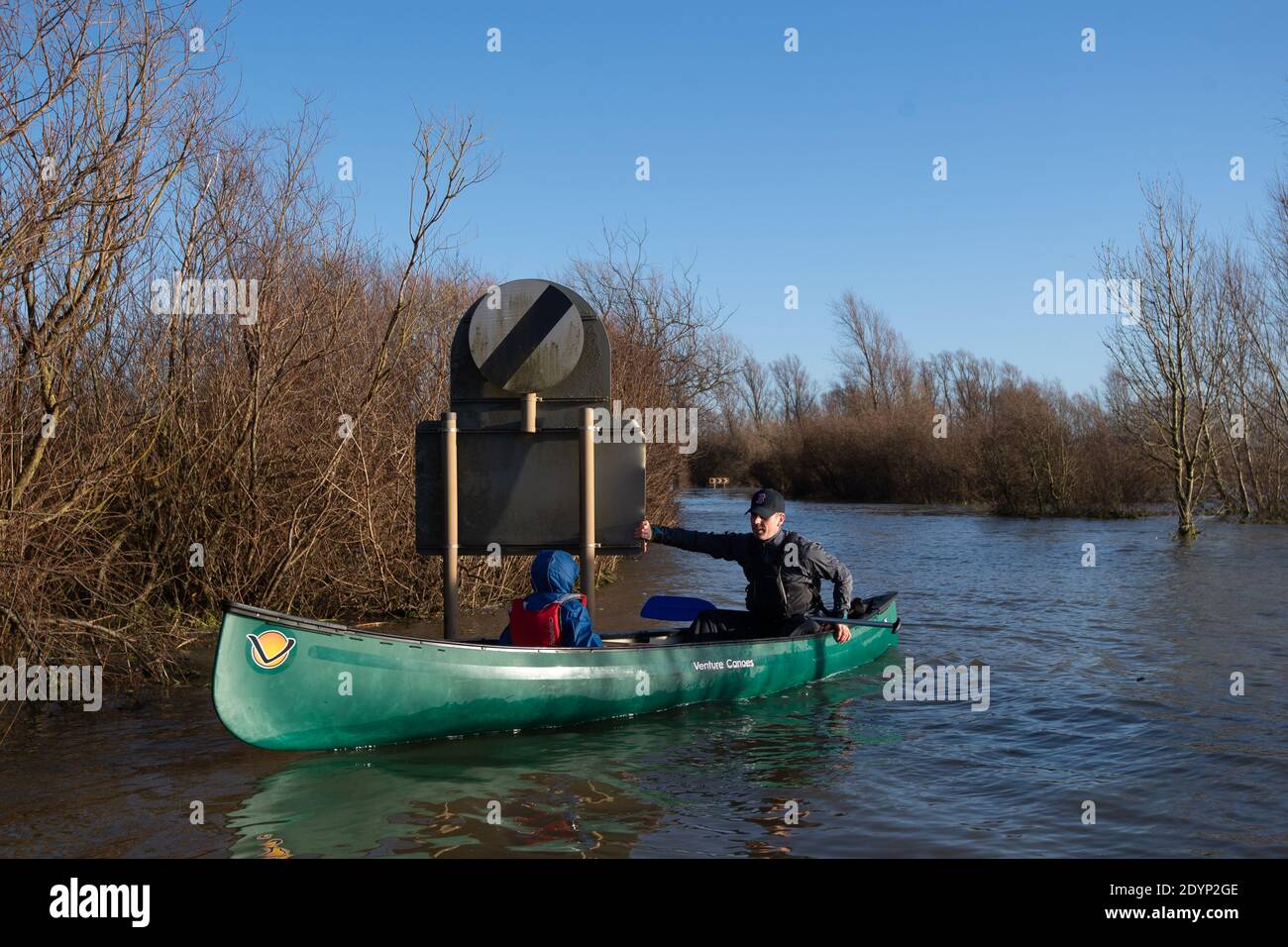 Anthony Gleave and his son Arthur, 3, canoe along the flooded A1101 in ...
