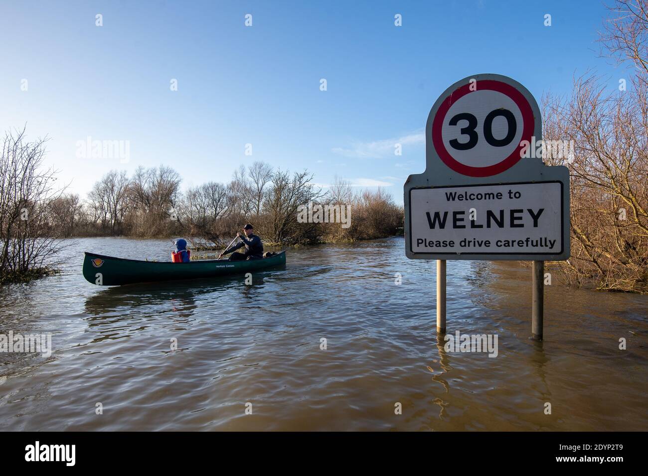 Anthony Gleave and his son Arthur, 3, canoe along the flooded A1101 in ...