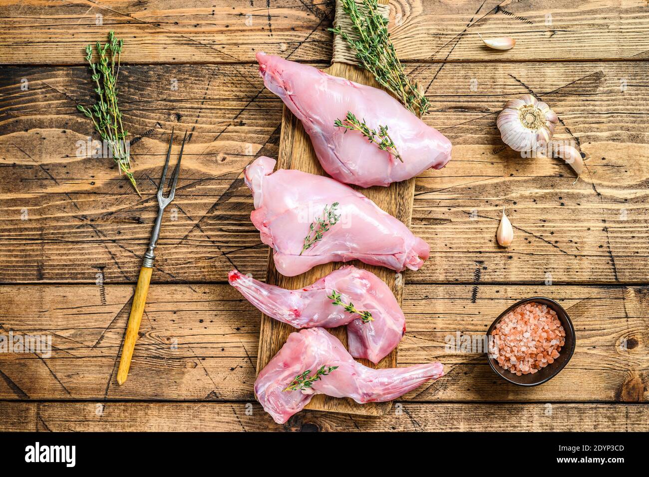 Raw rabbit legs on a cutting Board. Wooden background. Top view Stock ...