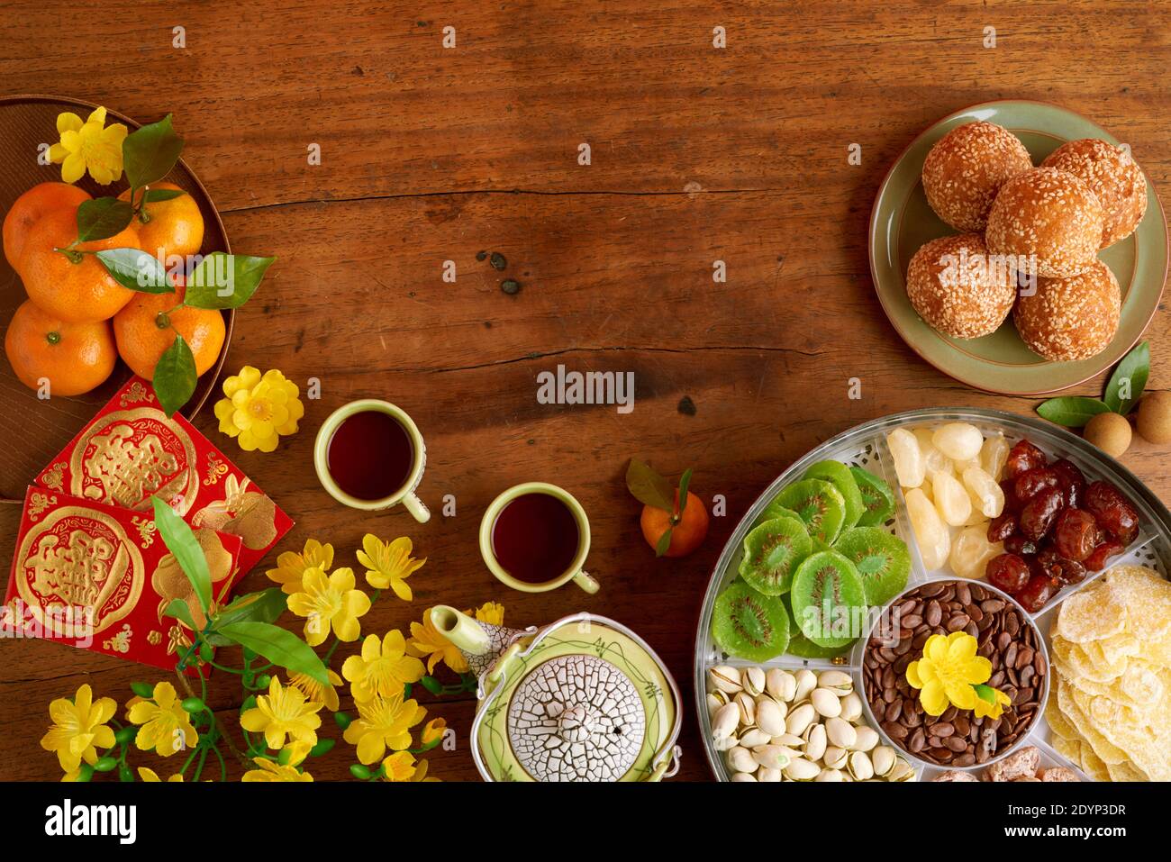Plate with fried rice balls, nuts and dried fruits on wooden table with ...