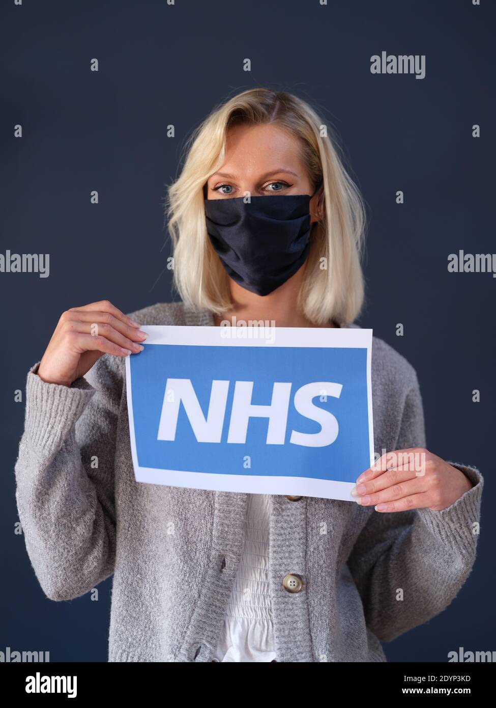 Portraits of Girl wearing Covid Coronavirus Mask holding NHS sign and ...