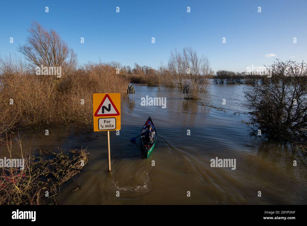 Anthony Gleave and his son Arthur, 3, canoe along the flooded A1101 in ...