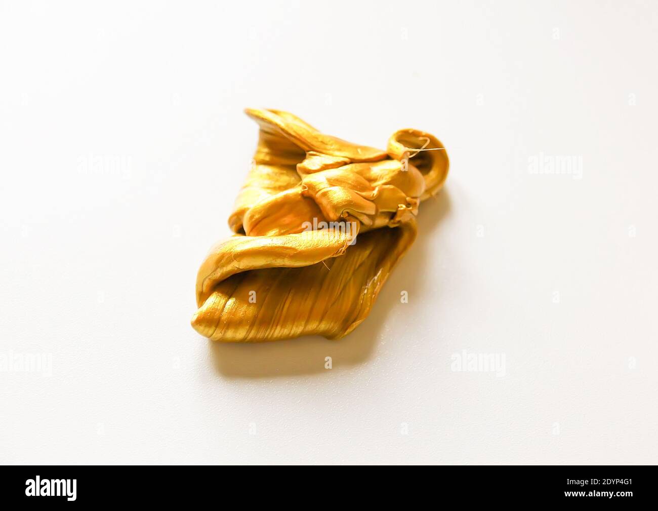Gold slime on white background Stock Photo - Alamy