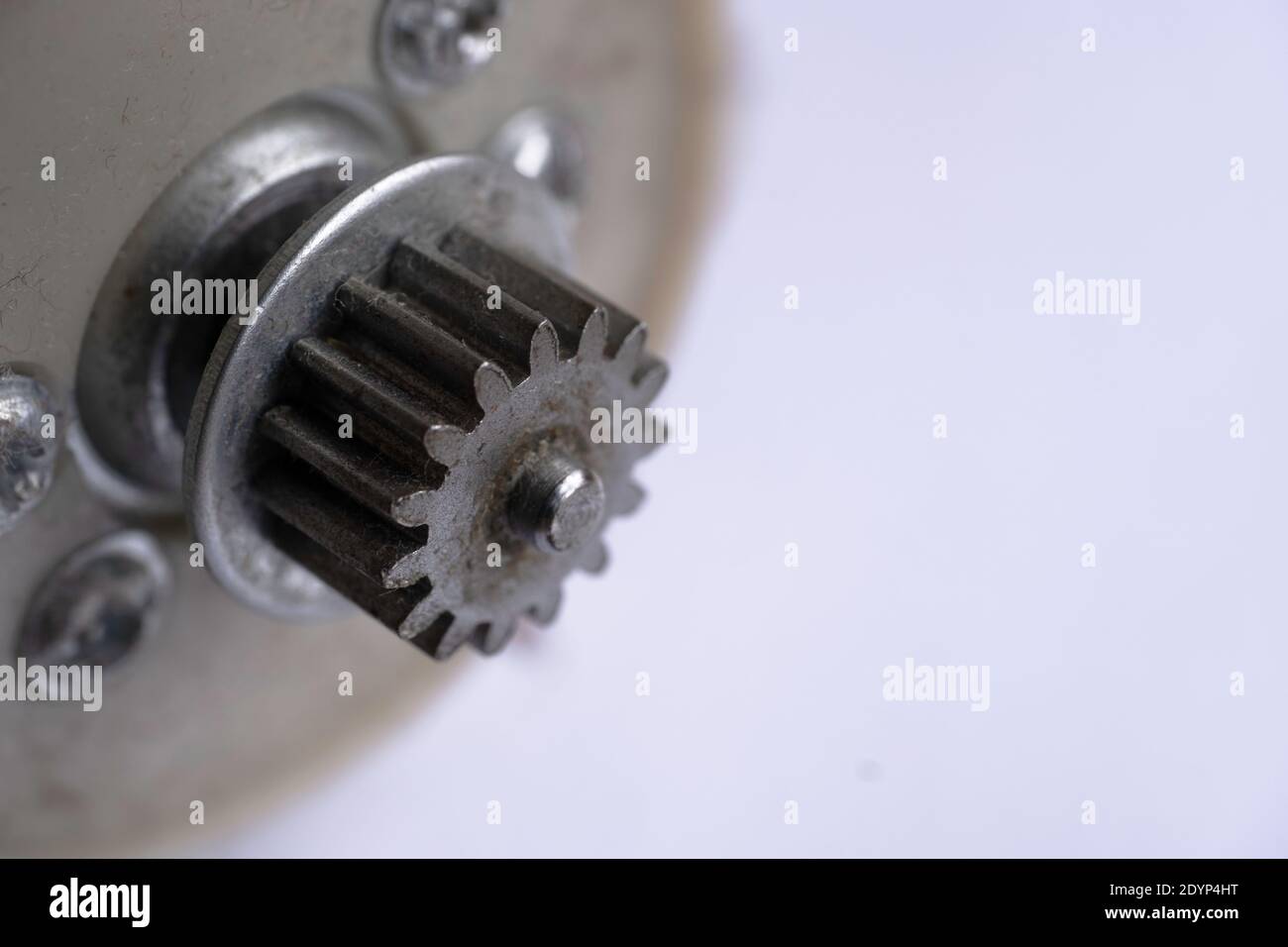 Used metal gear on a round machine on a light background. Side view ...