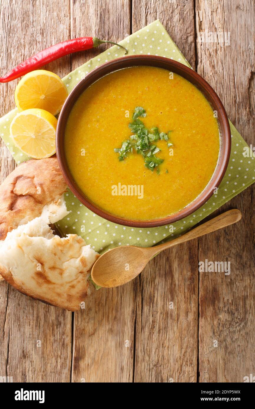 Shorbat Adas Red Lentil Soup closeup in the bowl on the table. Vertical ...
