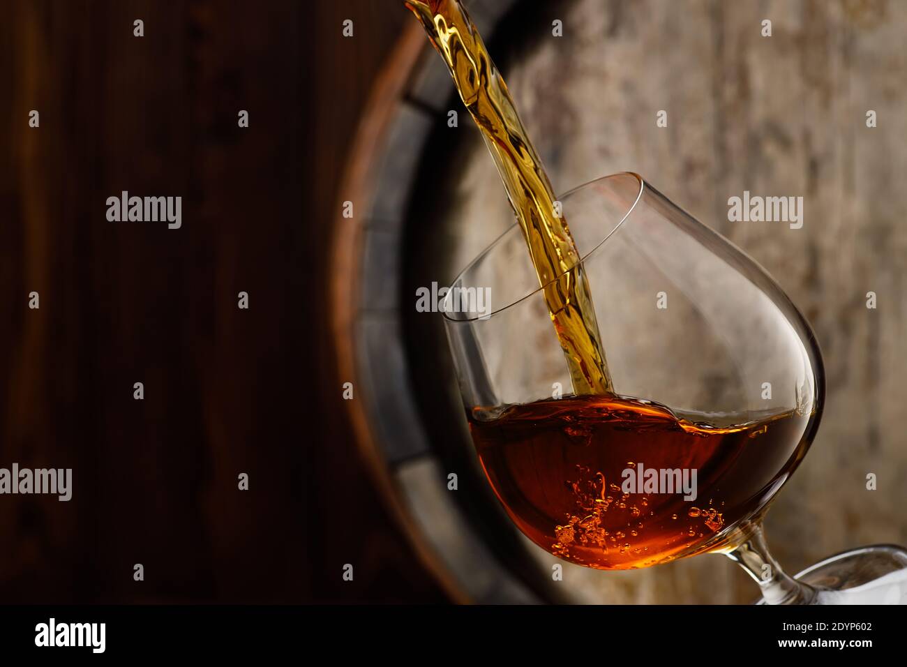 cognac pouring into snifter glass Stock Photo - Alamy