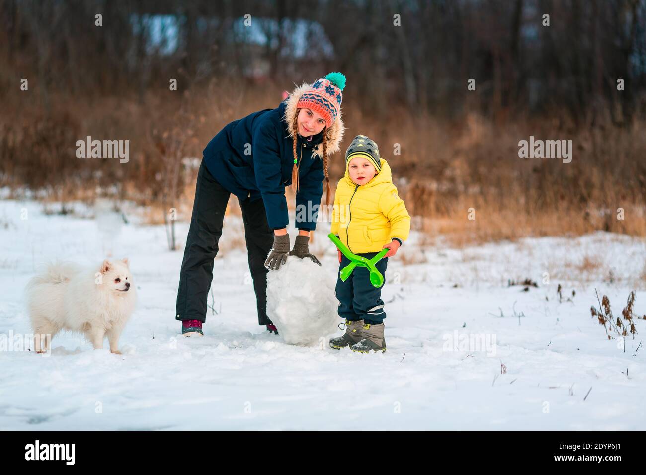 Rolling a big snowball hi-res stock photography and images - Alamy