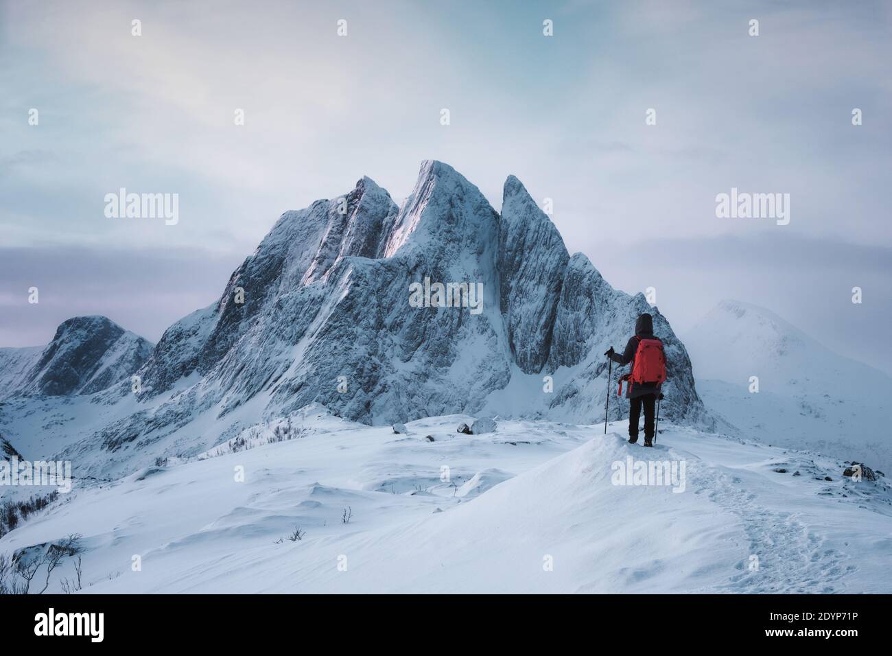 Mountaineer woman standing on top of Segla peak with majestic mountain ...