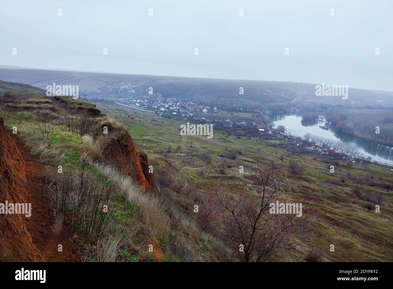 Scenery with village on the riverside valley . Rustic nature with river ...