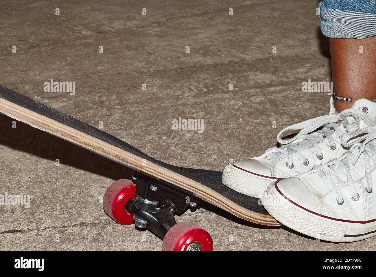 A skateboard with a girl's feet wearing slippers. Girl doing sport on a ...