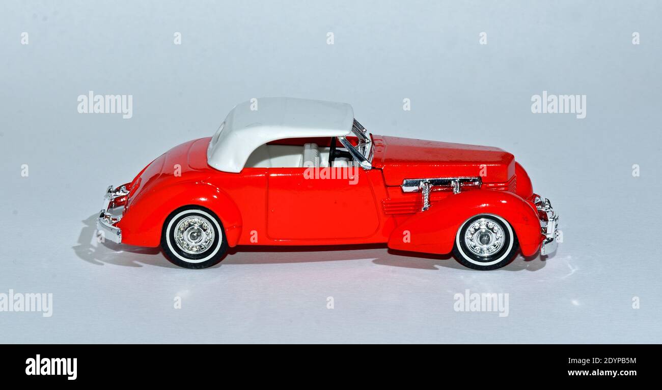 Toy 1937 Vintage Red Cord 812 Car with white background Stock Photo - Alamy