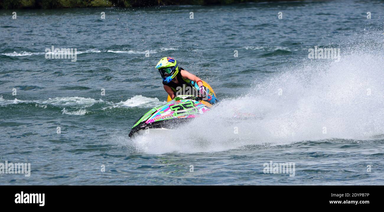 Jet Ski race competitor cornering at speed creating at lot of spray ...