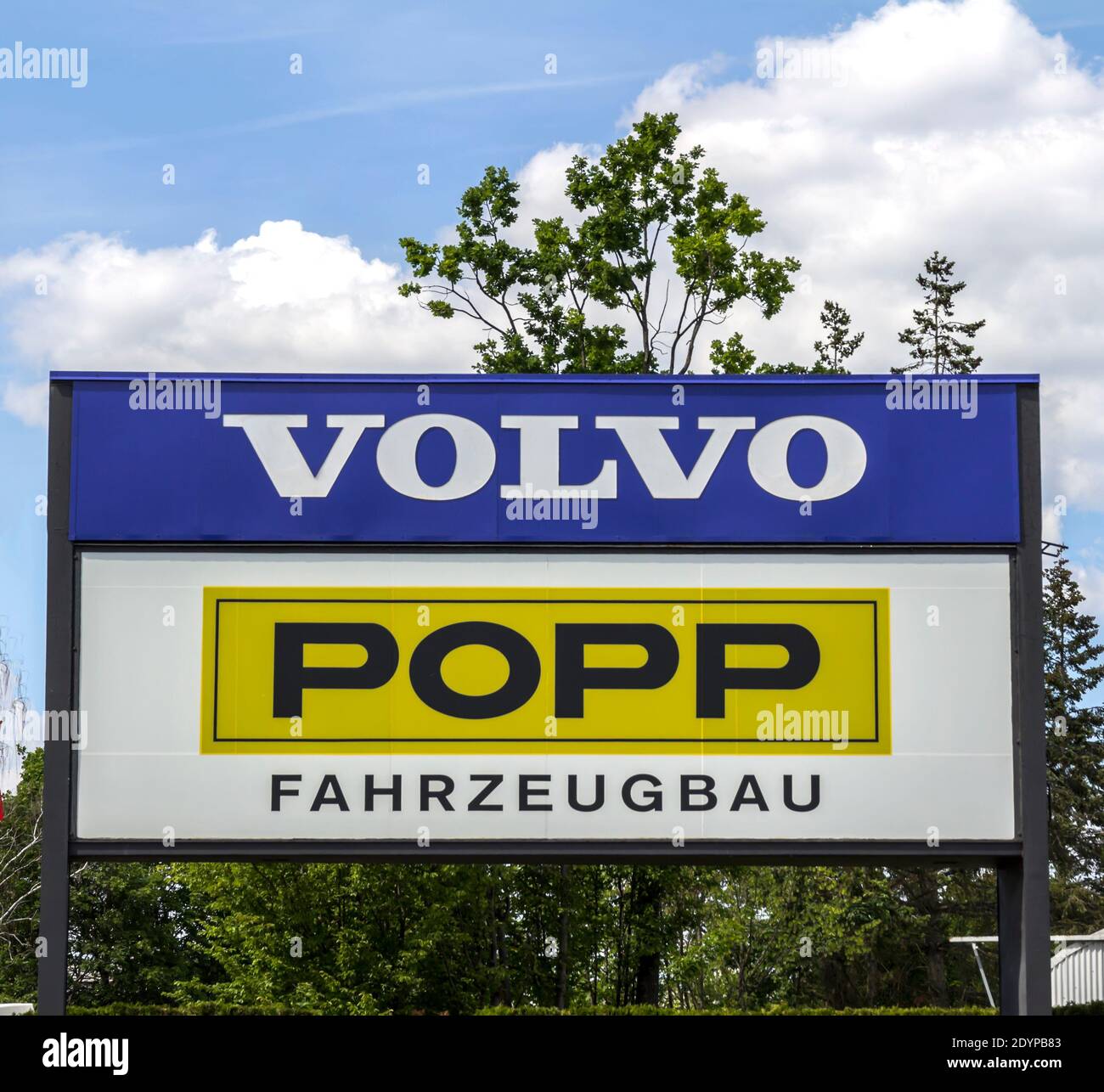 Volvo Car Dealership with commercial signs. Volvo cars, stylized as ...