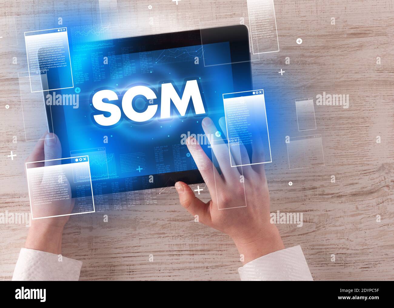 Close-up of a hand holding tablet with SCM abbreviation, modern technology concept Stock Photo ...