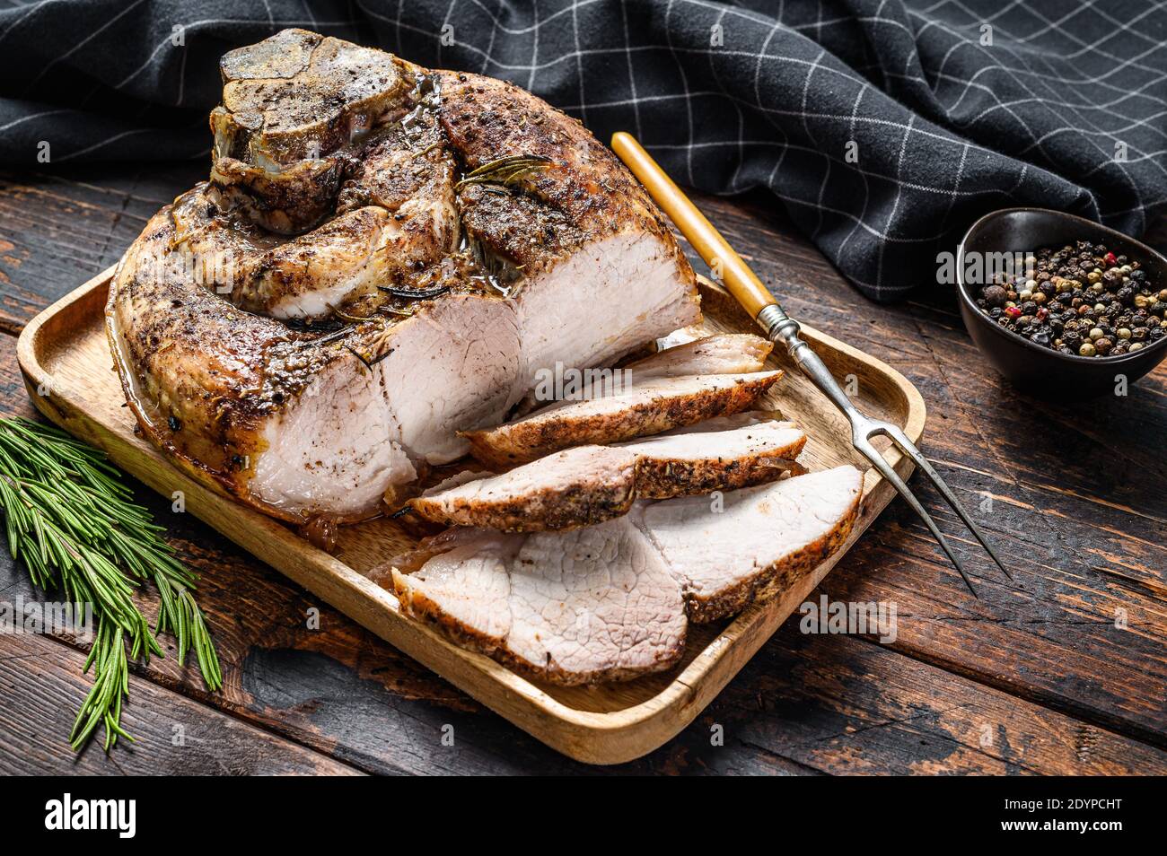 Baked sliced pork leg knuckle. Dark wooden background. Top view Stock ...