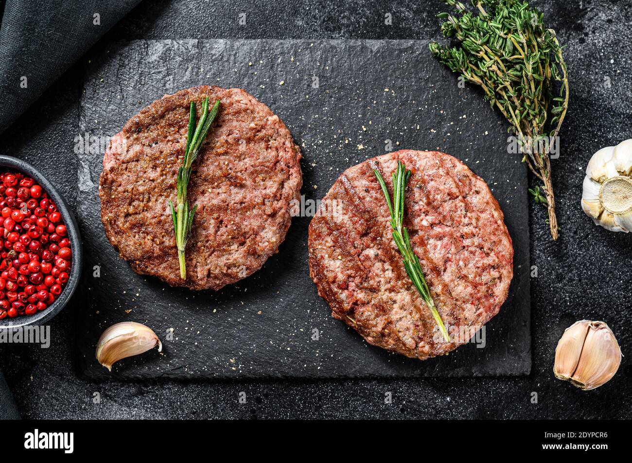 Grilled ground beef patties. BBQ meat. Black background. Top view Stock ...
