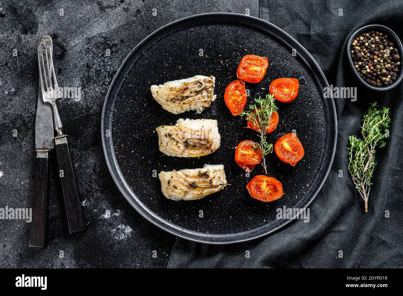 A portion of Grilled, baked pollock or coalfish fillets. Black ...
