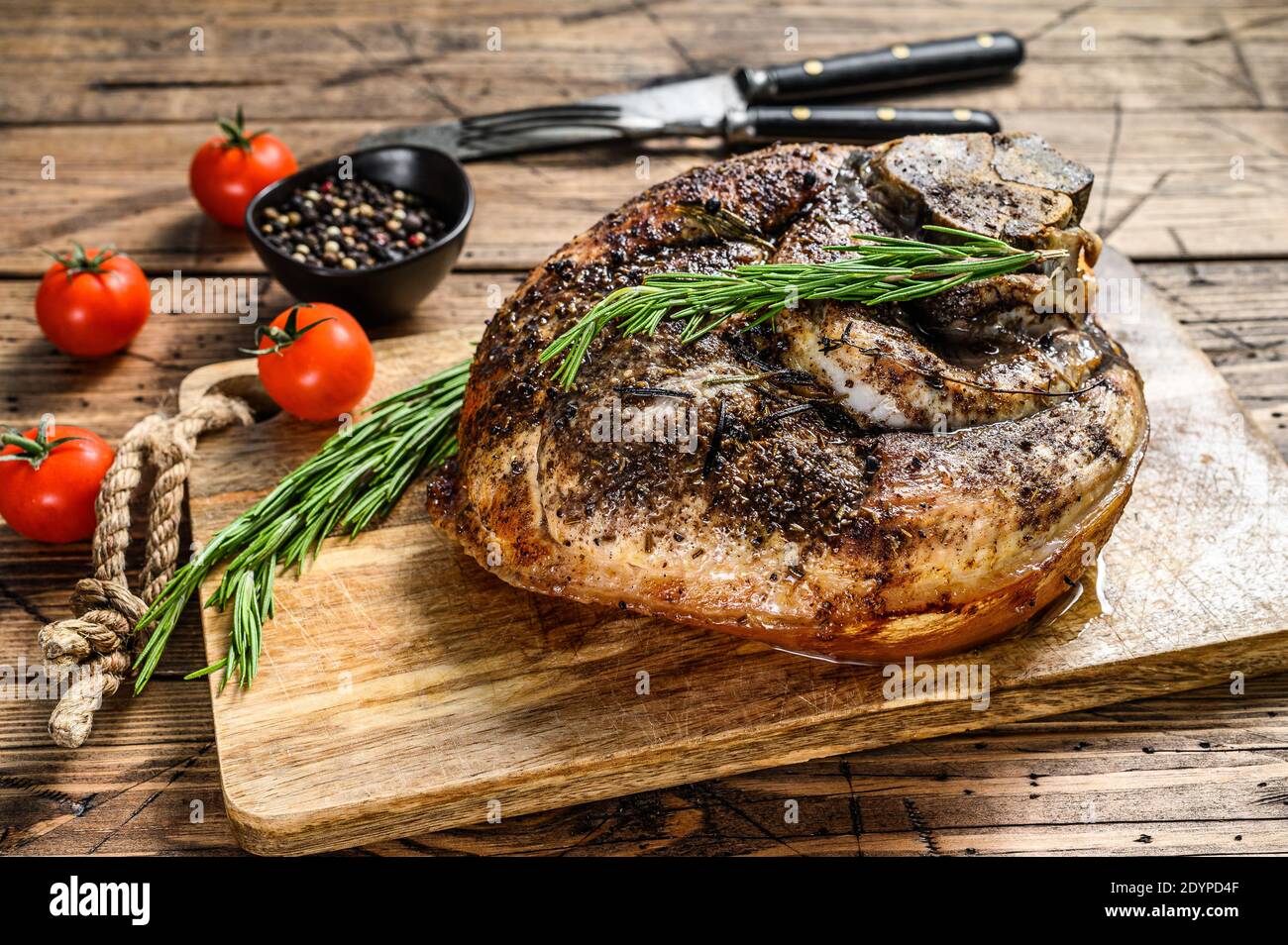Roast pork knuckle on a wooden board. Leg meat. Wooden background. Top ...