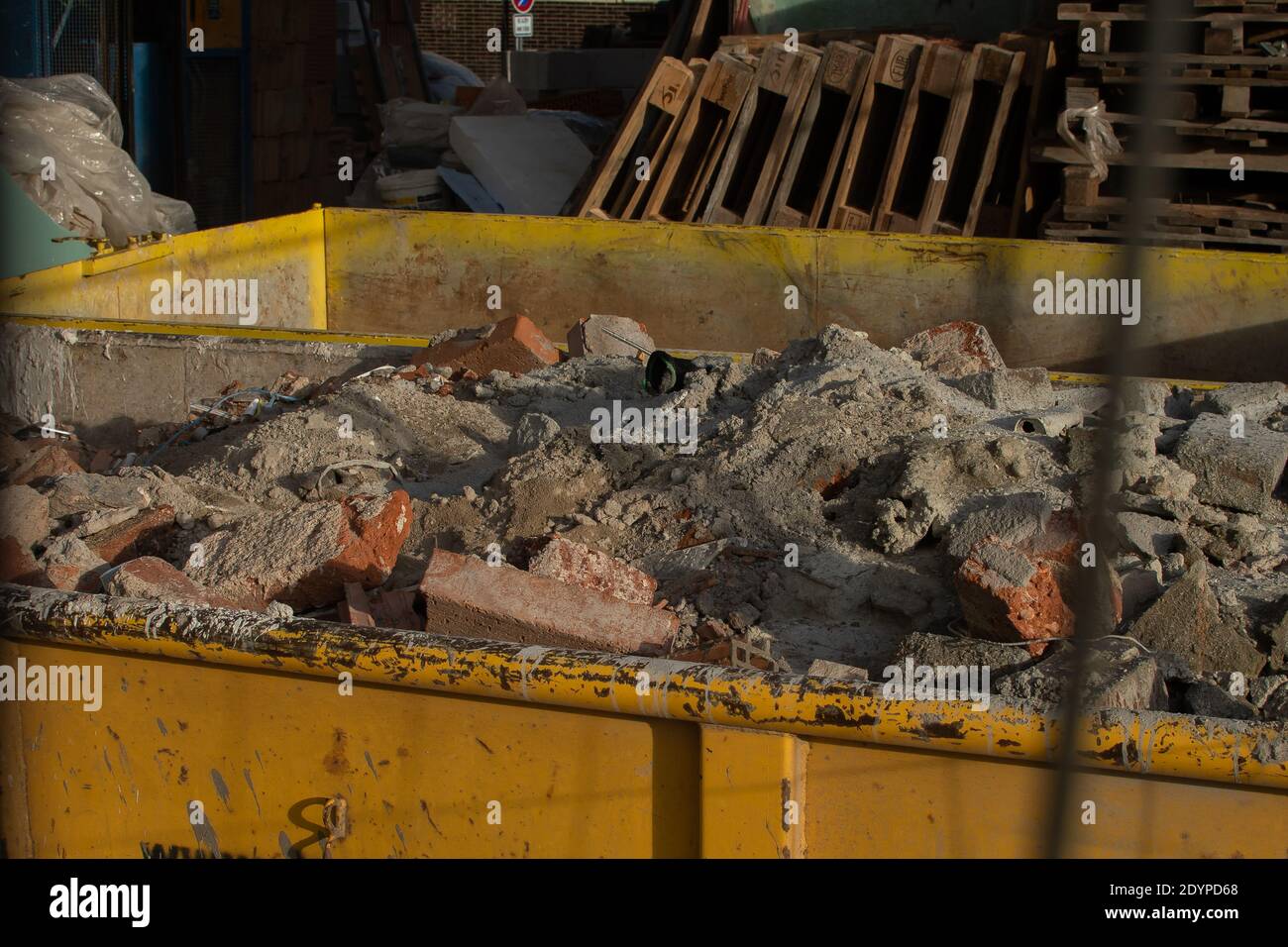 Bricks from demolition in container. Container with rubbish ...