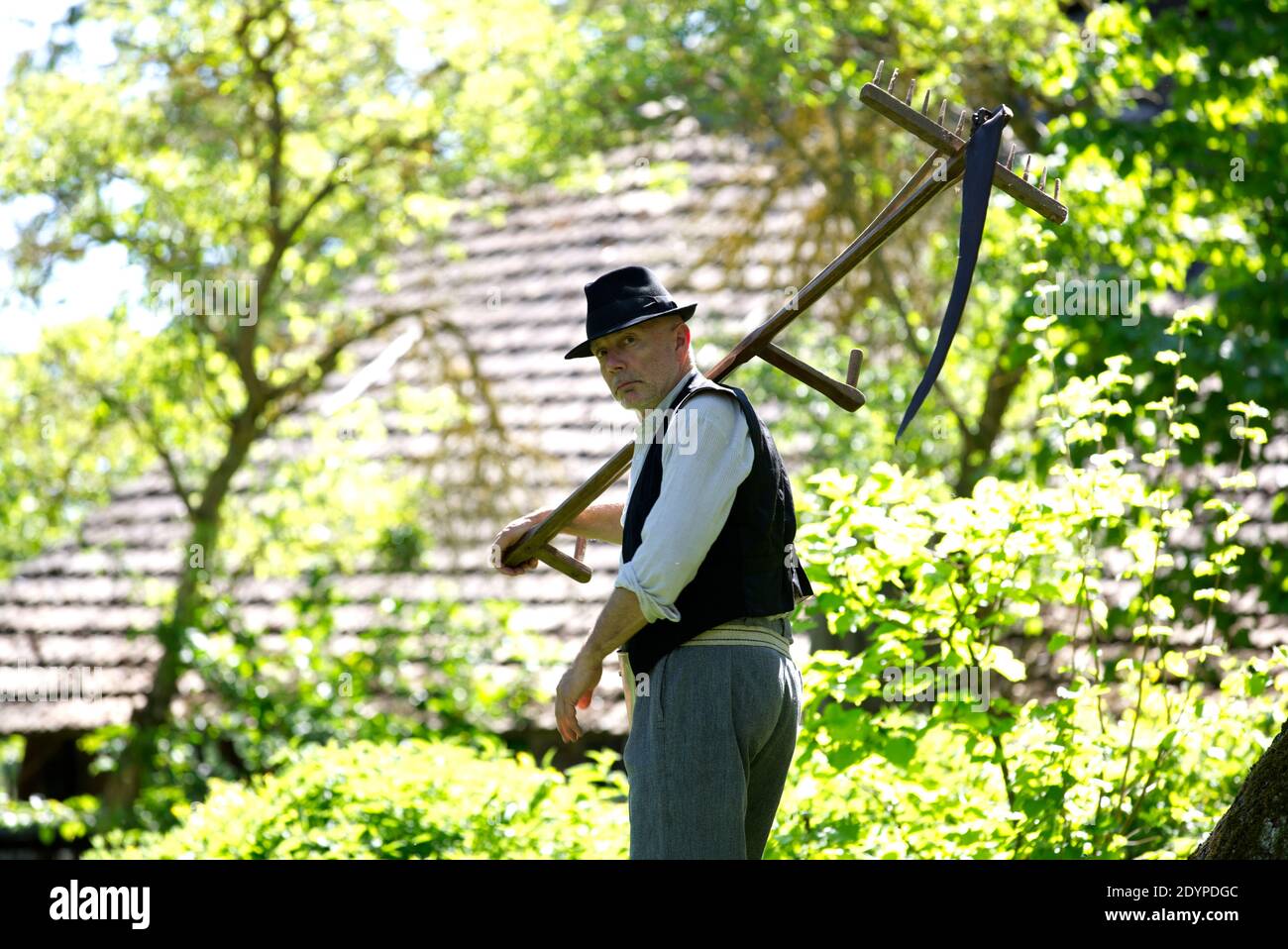 old farmer with scythe and rakes Stock Photo - Alamy