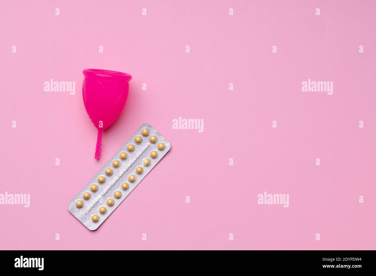 Menstrual cup and oral contraceptive pills top view Stock Photo - Alamy