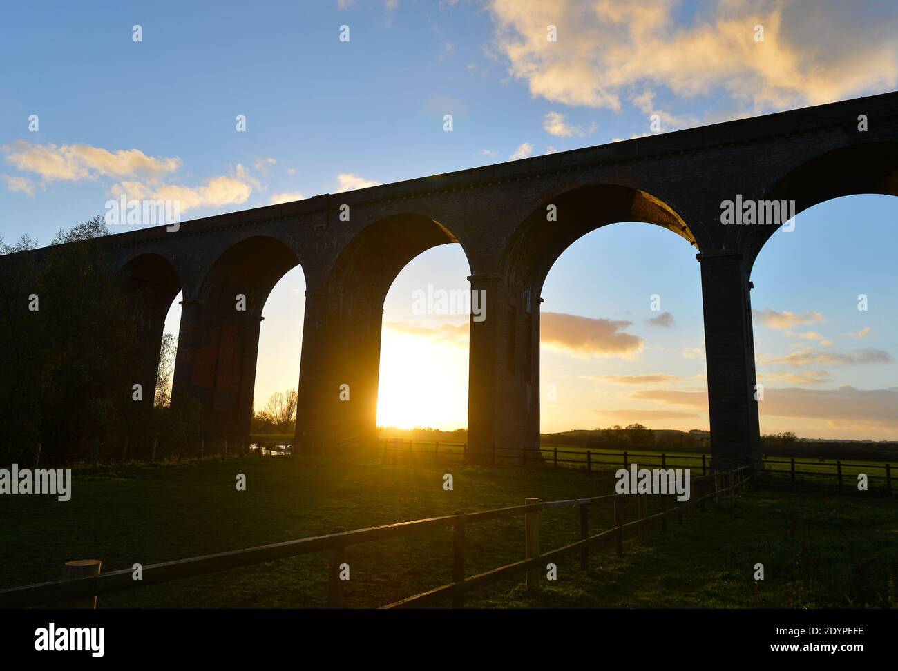 The sun sets behind Harringworth Viaduct also known as the Welland ...