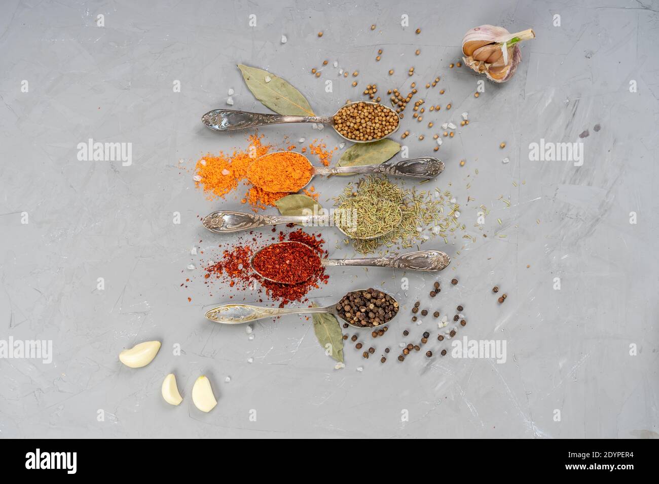 various spices in metal silver spoons with large crystals salt Stock ...