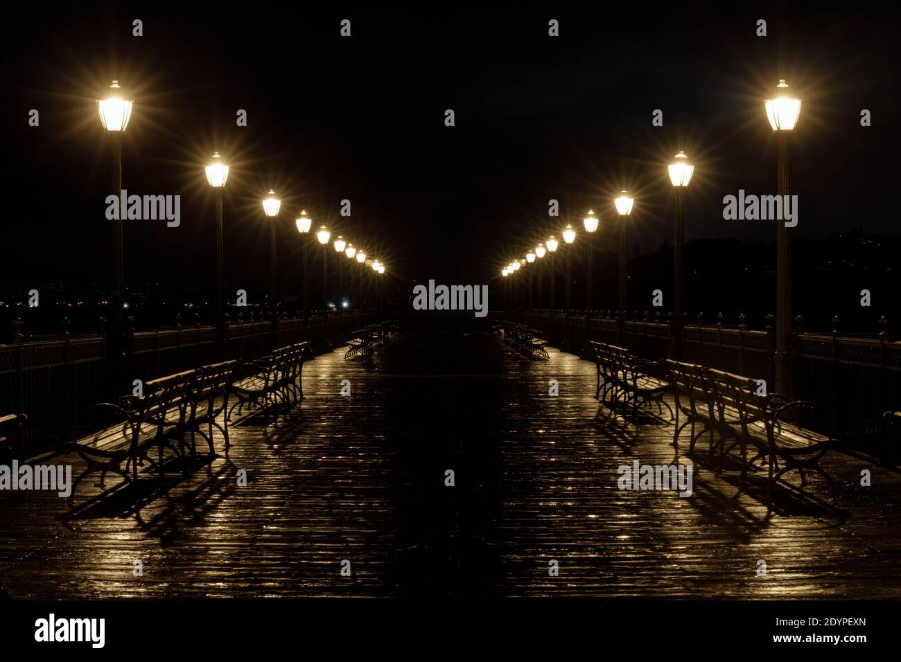 Lamp Posts and Rain Reflections Glow at Pier 7 Stock Photo - Alamy