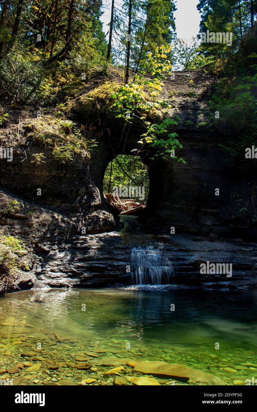 Quiet waterfalls from an artificial hole. Hole in the wall is an ...