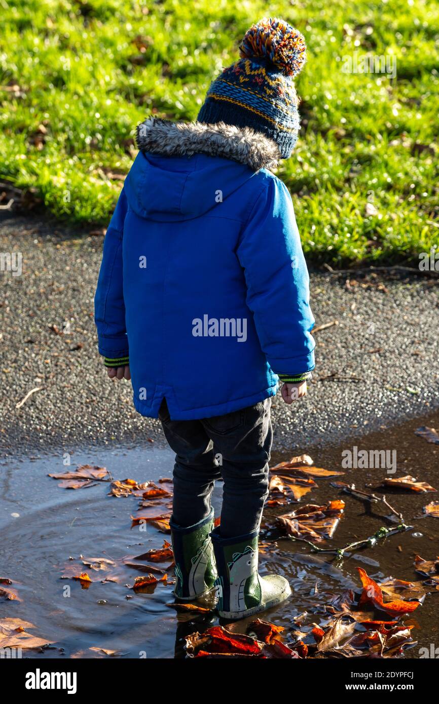 Boy jumping in puddle hi-res stock photography and images - Alamy