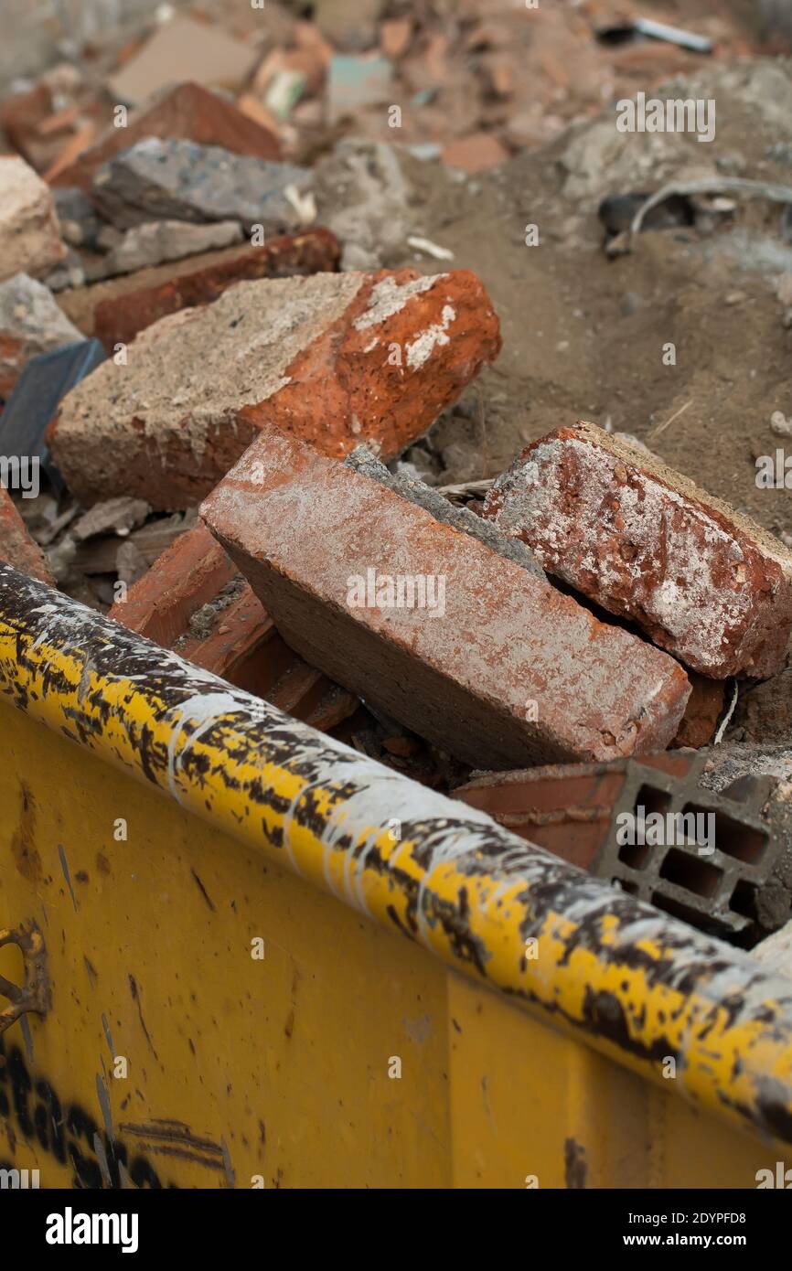 Bricks from demolition in container. Container with rubbish ...