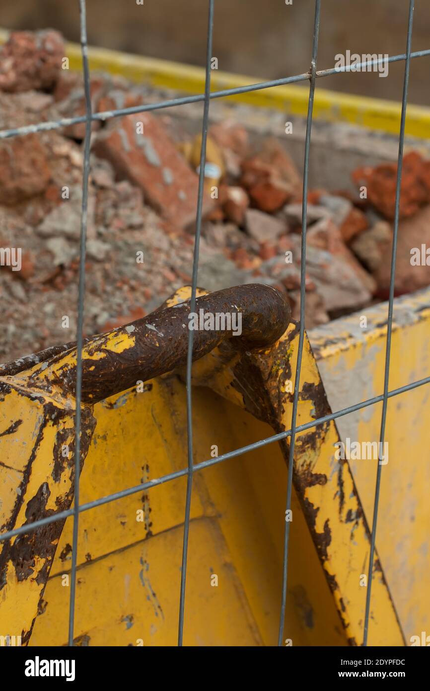 Bricks from demolition in container. Container with rubbish ...